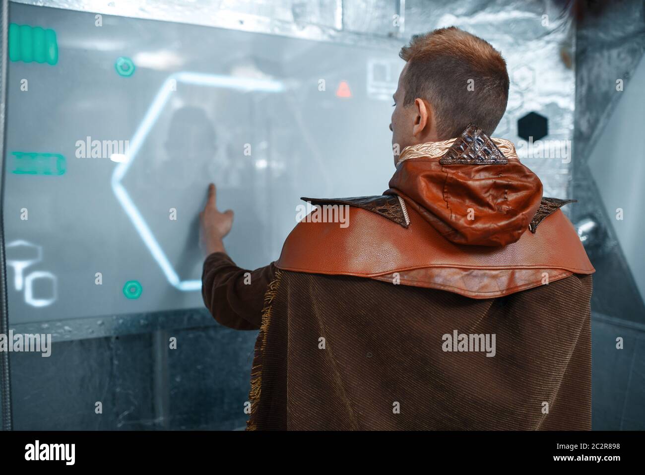 Intergalactic space scientist enter data on the teleport board ...