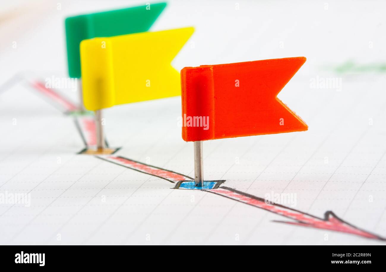 Colorful pins on sketched red arrow points Stock Photo - Alamy