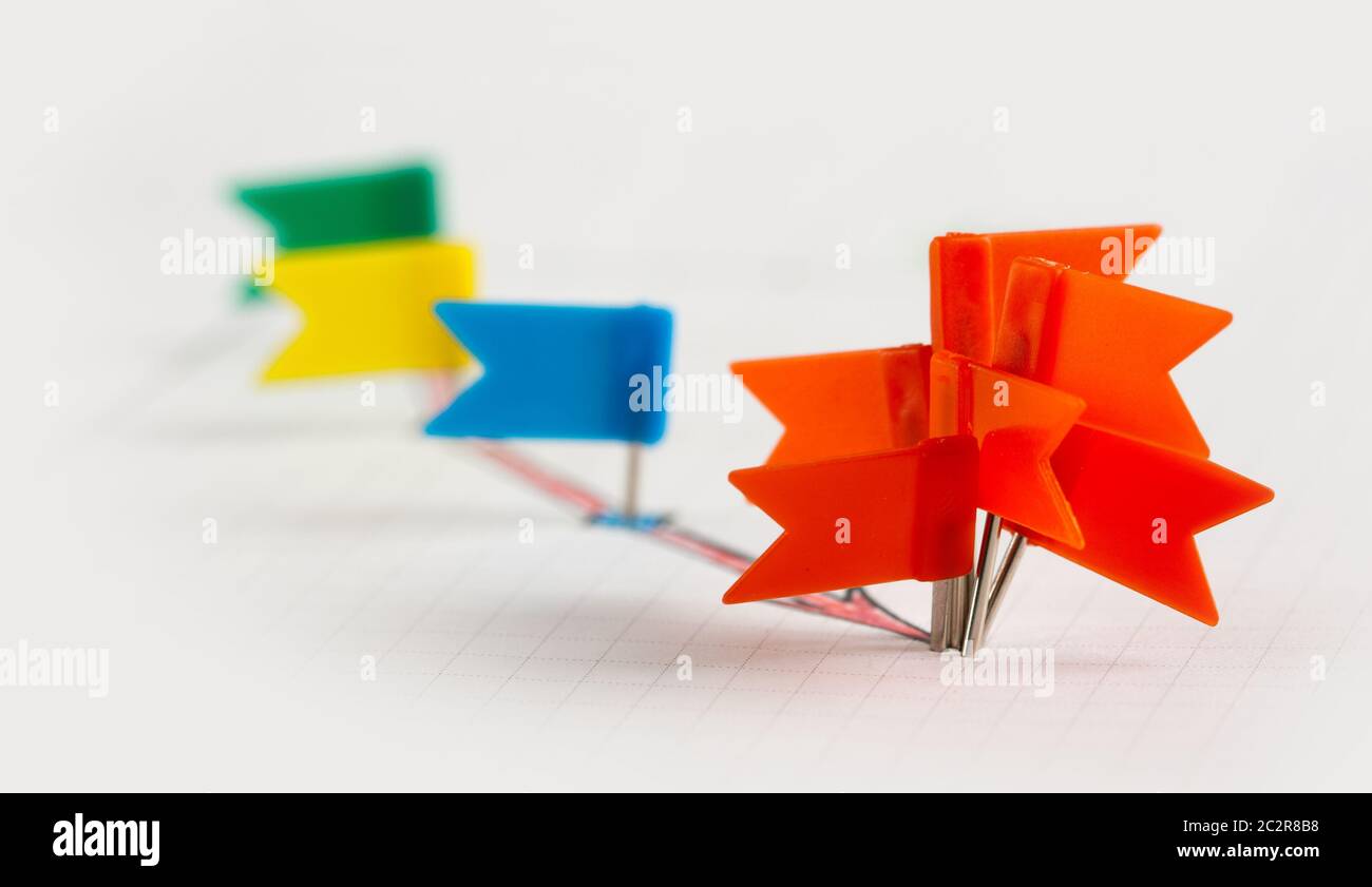Red pins on sketched red arrow points Stock Photo - Alamy