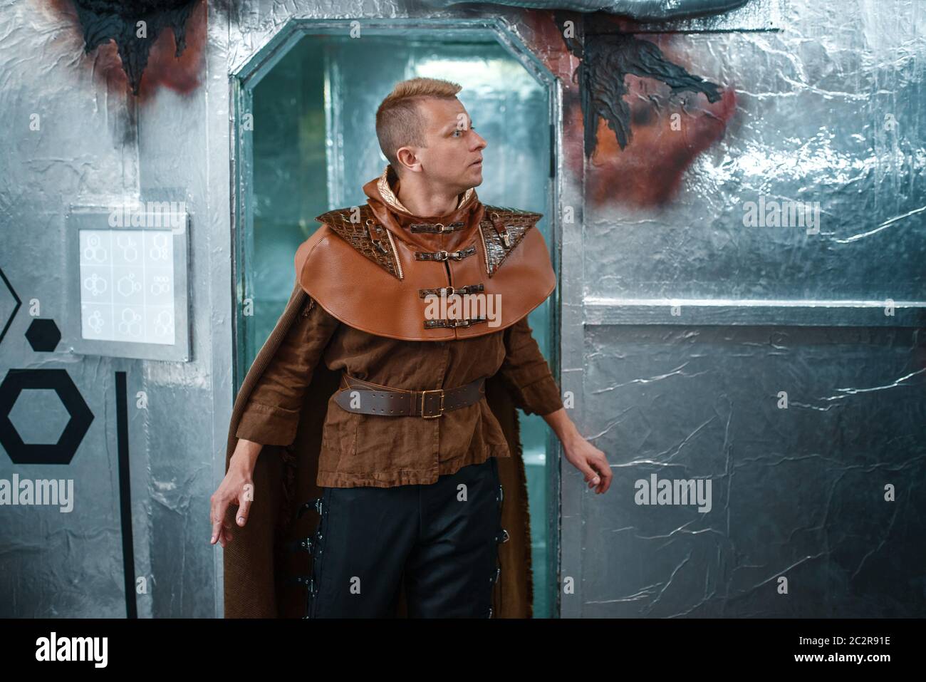 Space traveler looks out of the teleport with foil walls. Fantasy ...