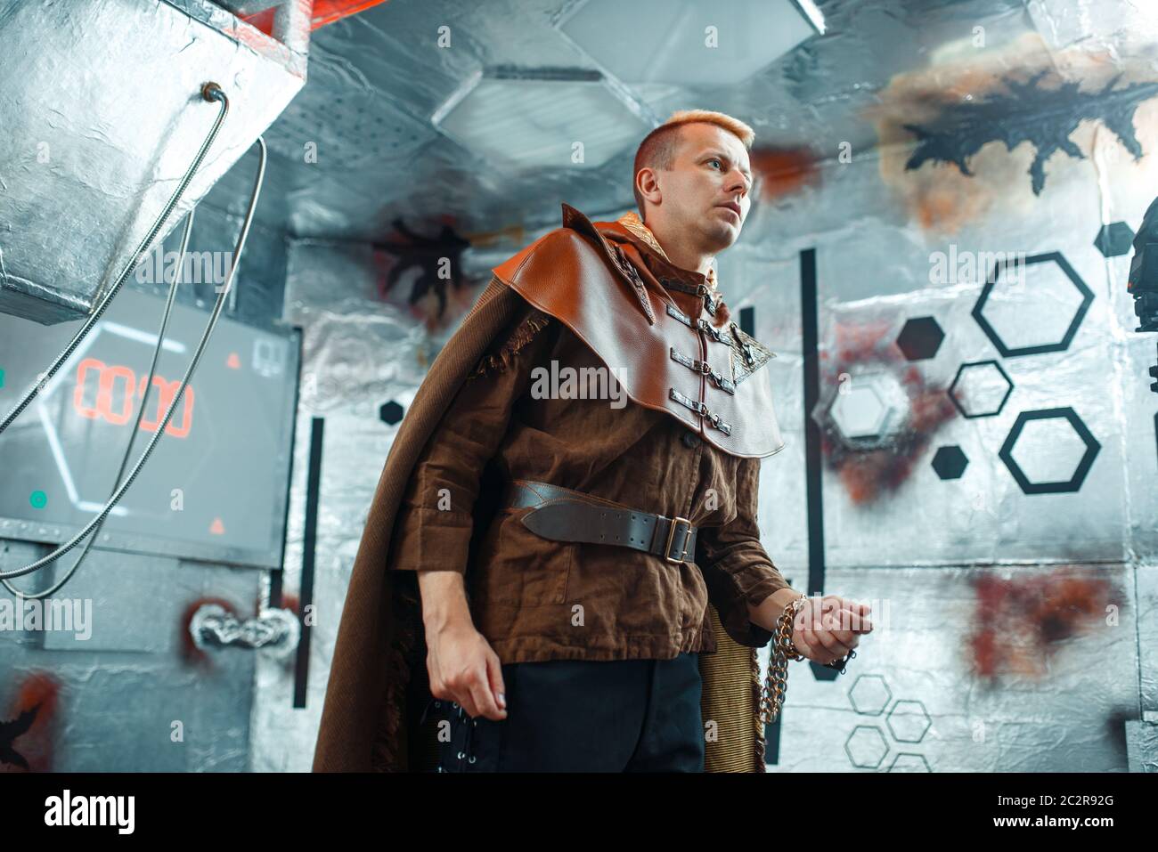 Space traveler on spacecraft command bridge, interior with foil walls ...