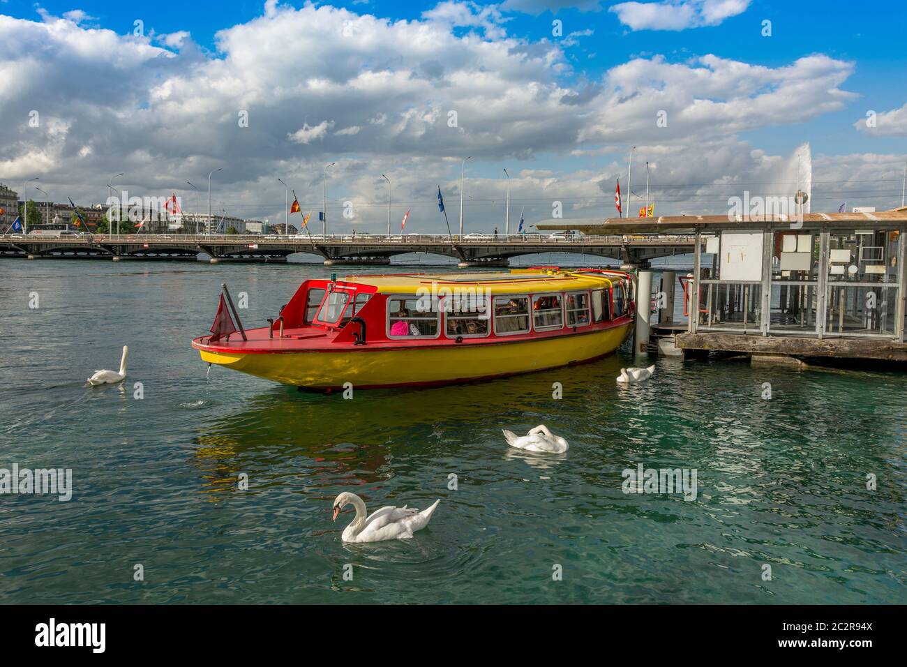 Water bus Mouette prepares for travel on Lake Geneva with Pont du Mont ...