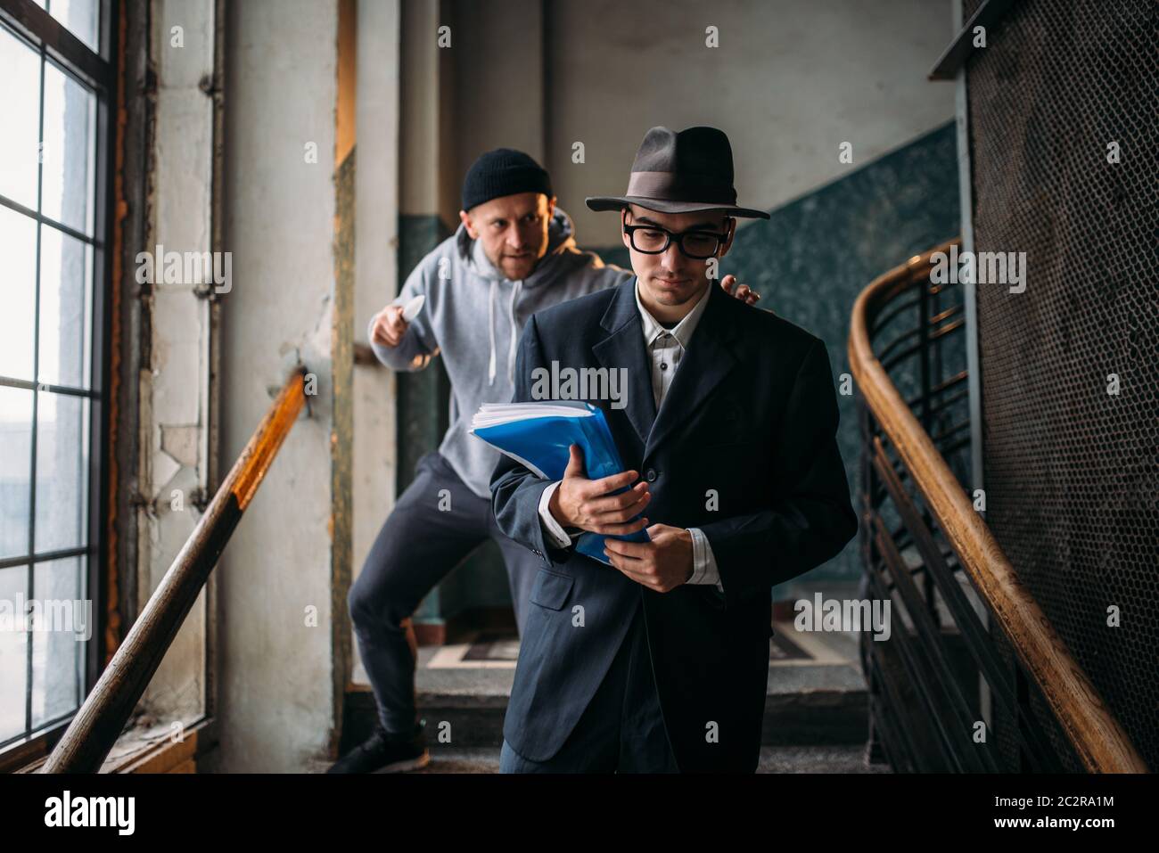 Aggressive robber with knife attack his victim. Street gangster commits ...