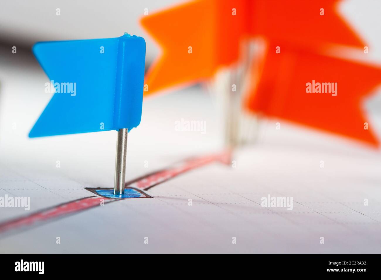 Colorful pins on sketched red arrow points Stock Photo - Alamy