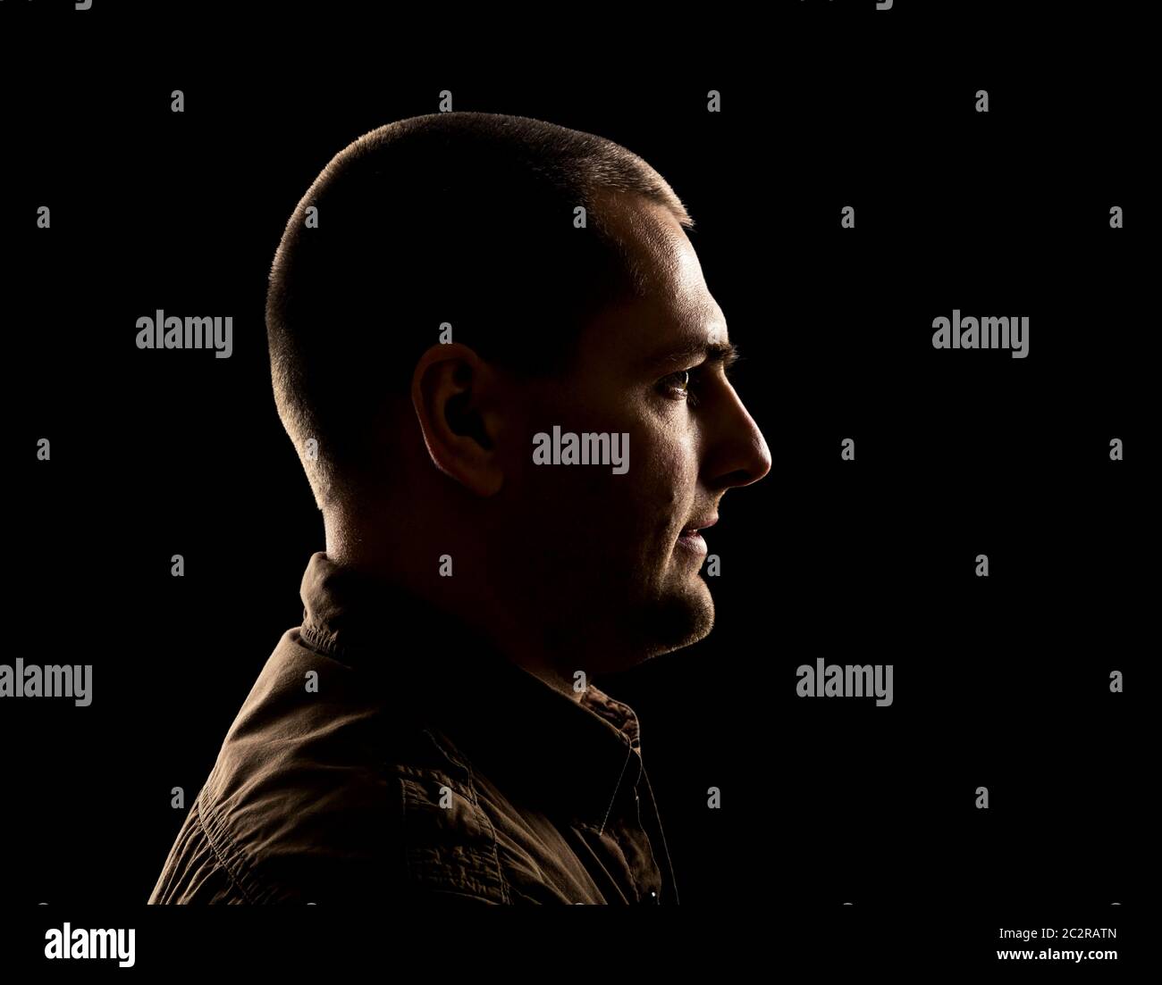 Side view of man's face upside down over black Stock Photo - Alamy