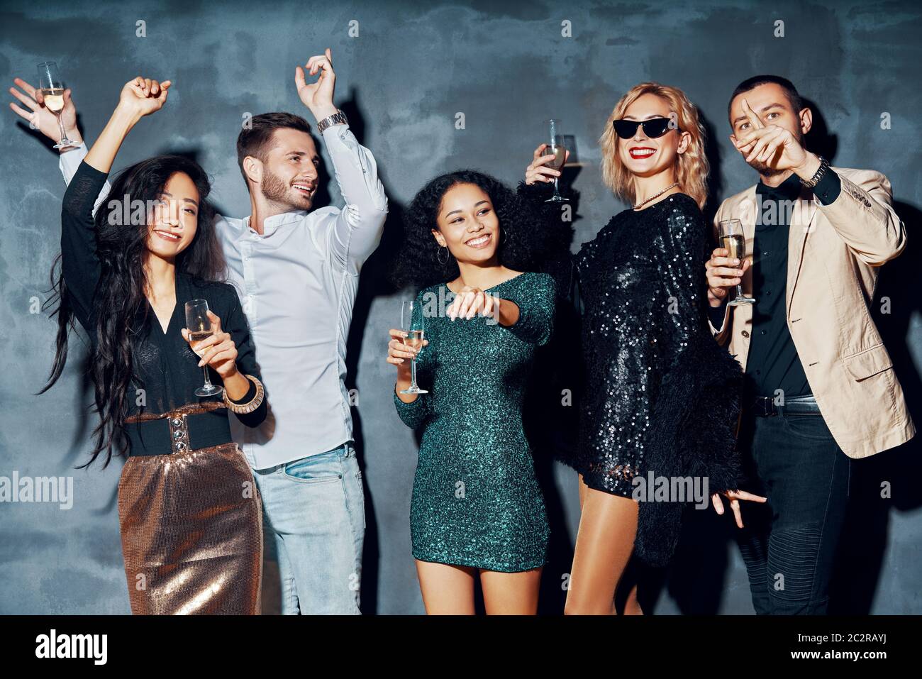 Diverse group of young people dancing in night club, enjoy party and ...