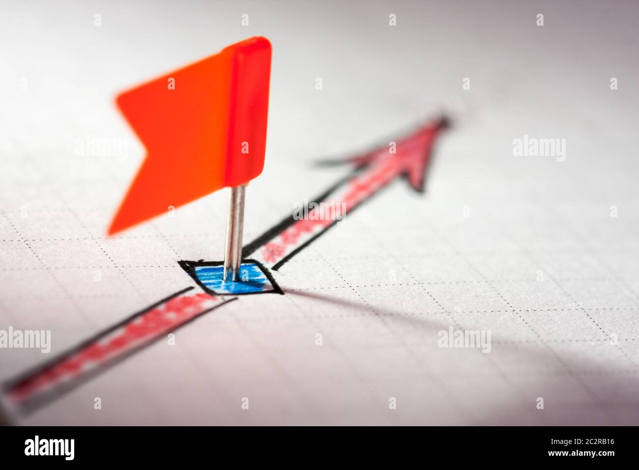 A pin on sketched red arrow on the paper Stock Photo - Alamy