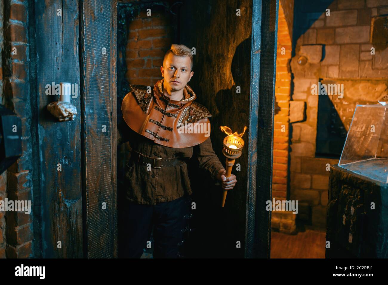 Traveler with torch in hand wandering the maze, solving ancient puzzle ...