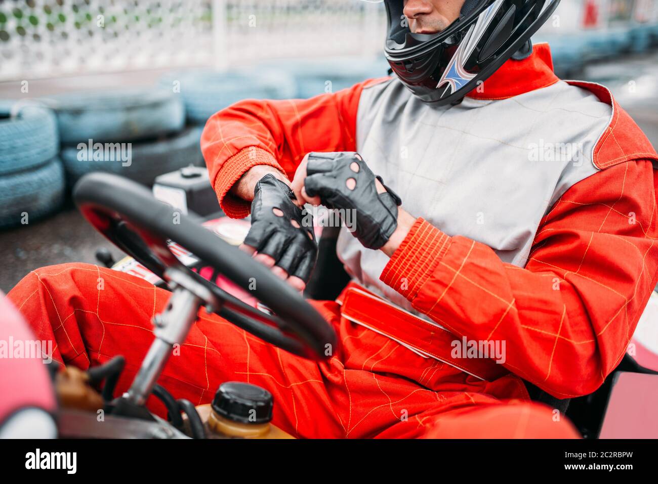 Go-kart driver in helmet on karting speed track. Carting race Stock ...