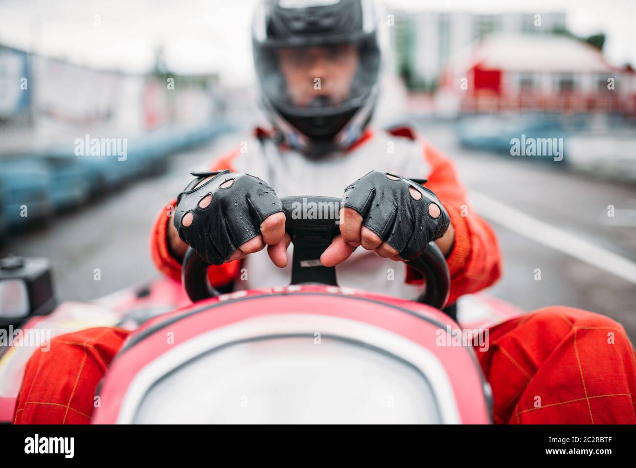 Karting race, go cart driver in helmet on carting speed track. Go-kart ...