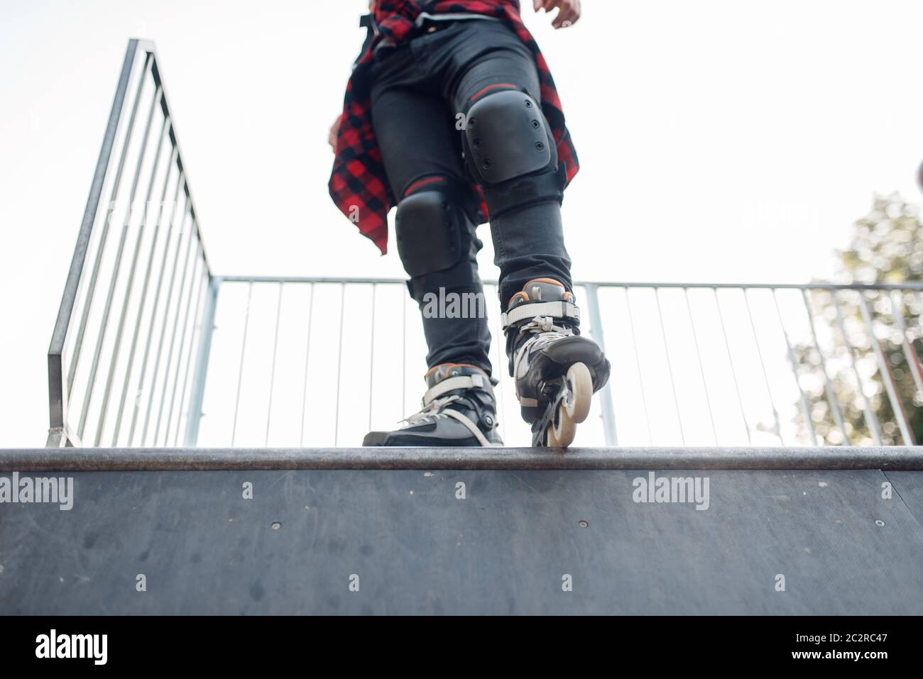 Roller skating, male skater standing on ramp. Urban roller-skating ...