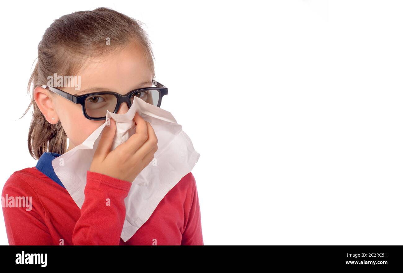 Girl has sniff and blow her nose with a tissue. Isolated on the white ...