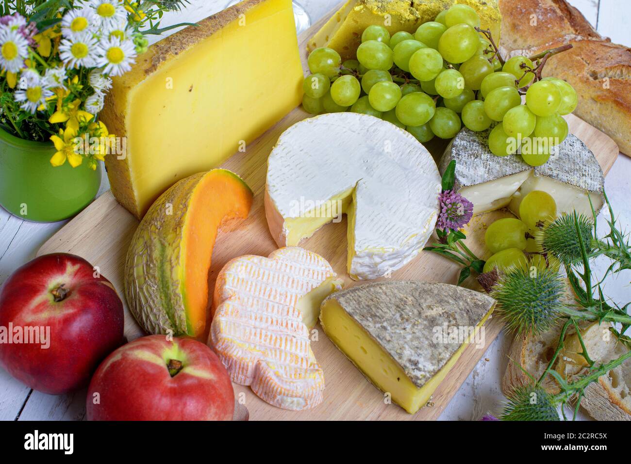 assortment of the french cheeses, camembert, tome, st albray and melon ...