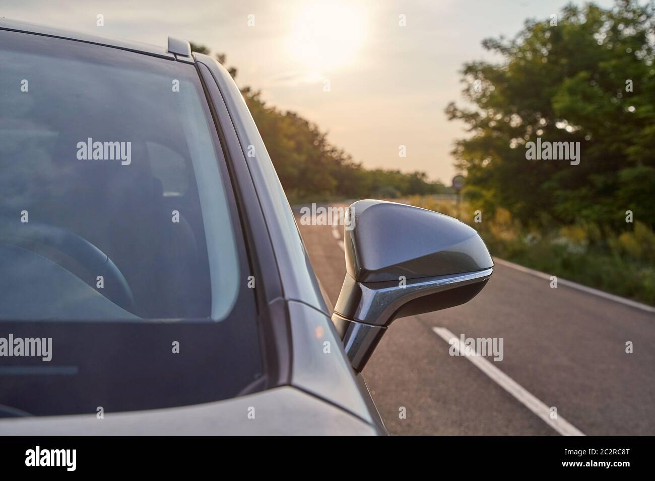 Car on the road, shiny detail reflecting sunset Stock Photo - Alamy
