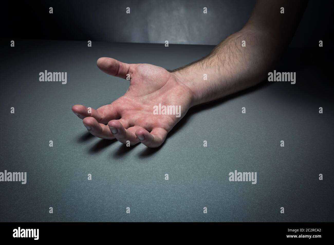 Human hand on the grey table Stock Photo - Alamy