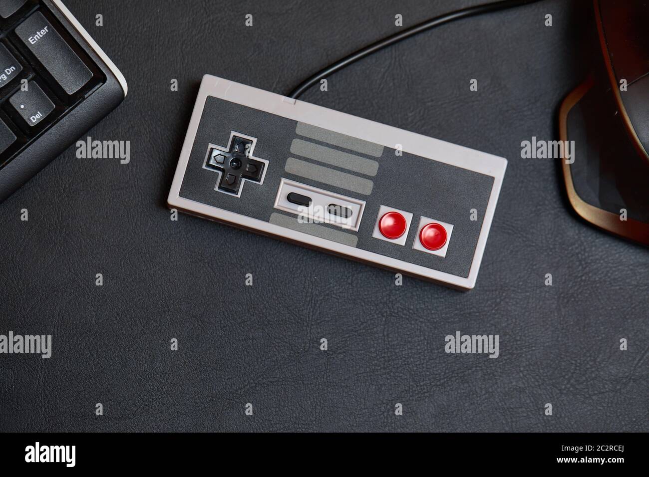 Old video game controller on a desk Stock Photo - Alamy