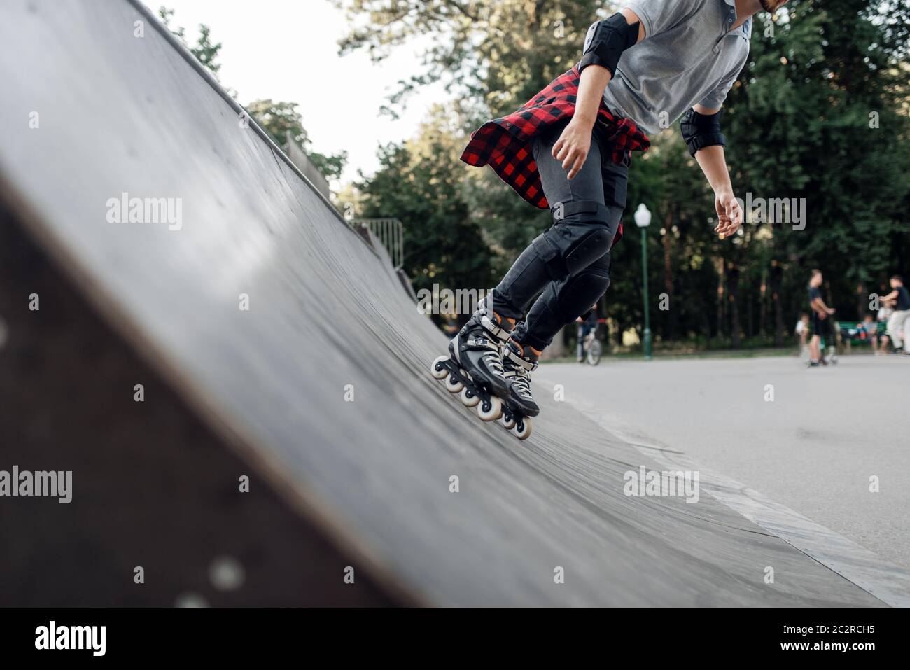 Roller skating, young male skater rolling off the ramp. Urban roller ...