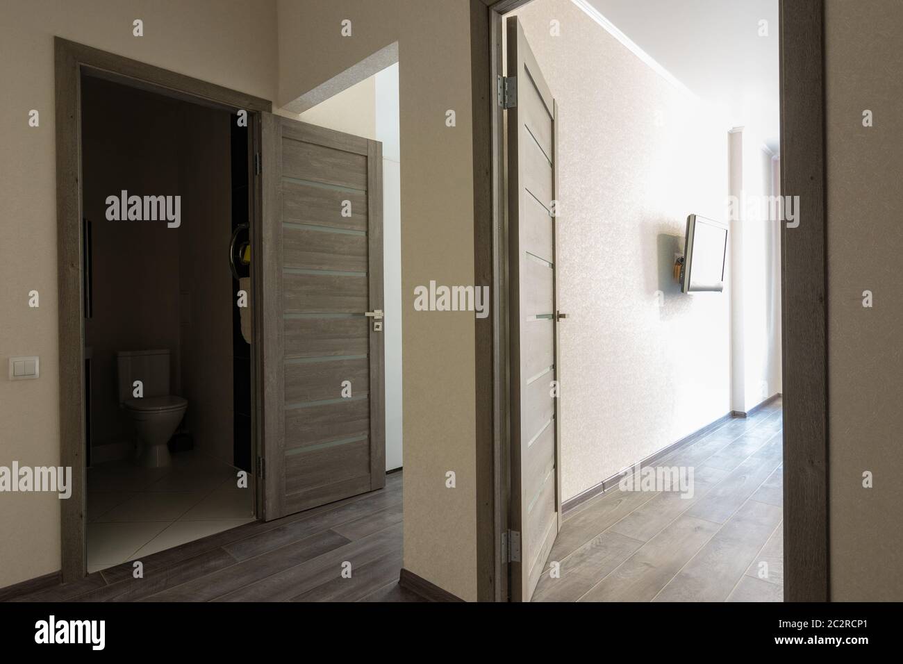 Corridor in a small apartment, open doors Stock Photo - Alamy