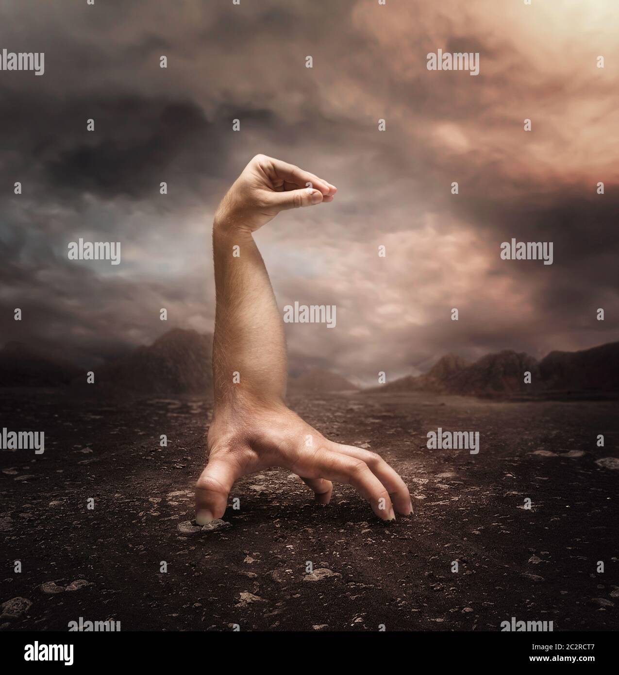 Strange human hand in the desert at sunset Stock Photo - Alamy
