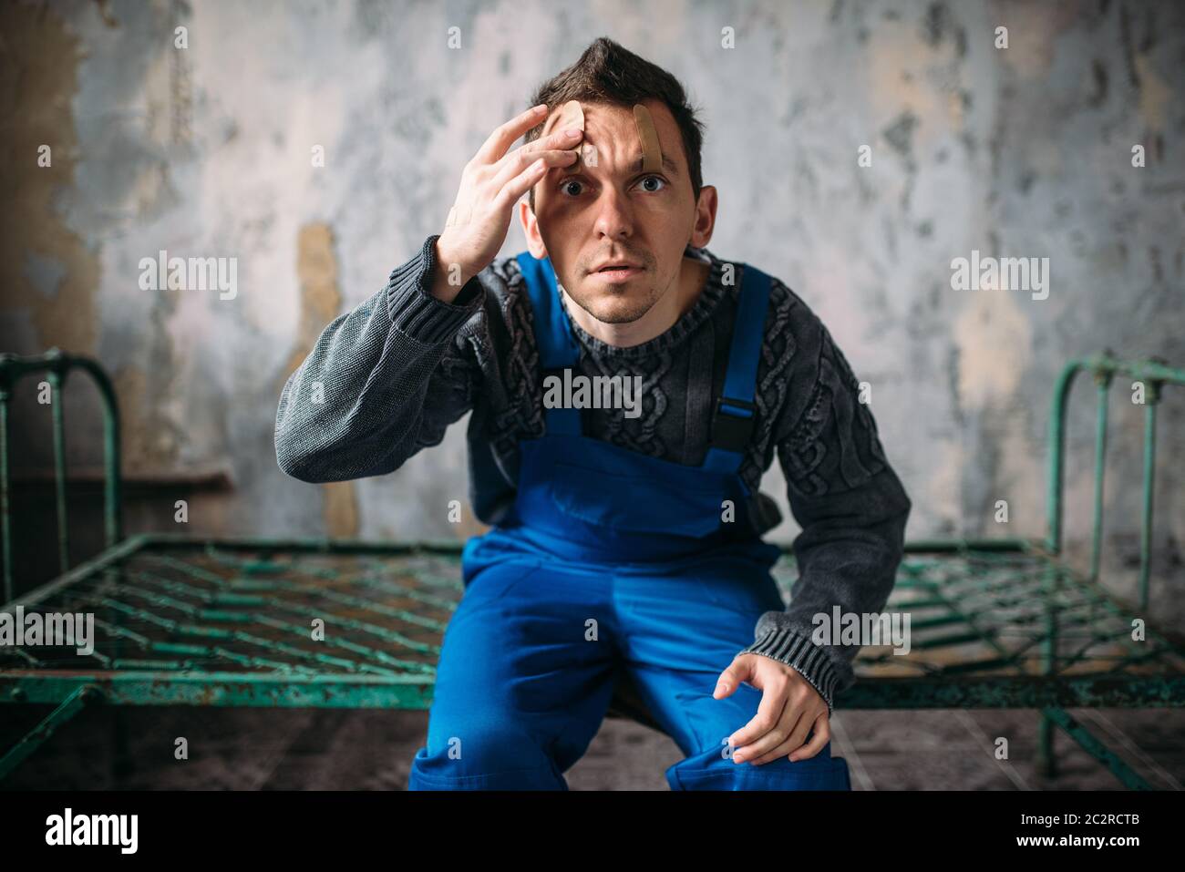 Madman in uniform mouth sealed with plaster, psycho patient. Mentally ...