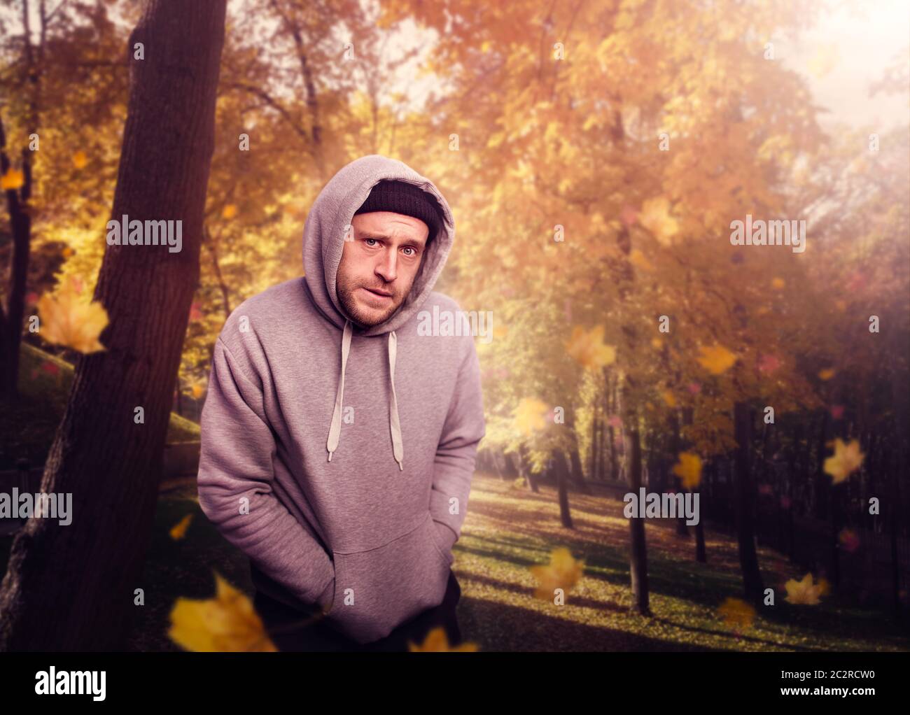 Gangster waiting for victim in autumn park. Crime concept, robbery ...