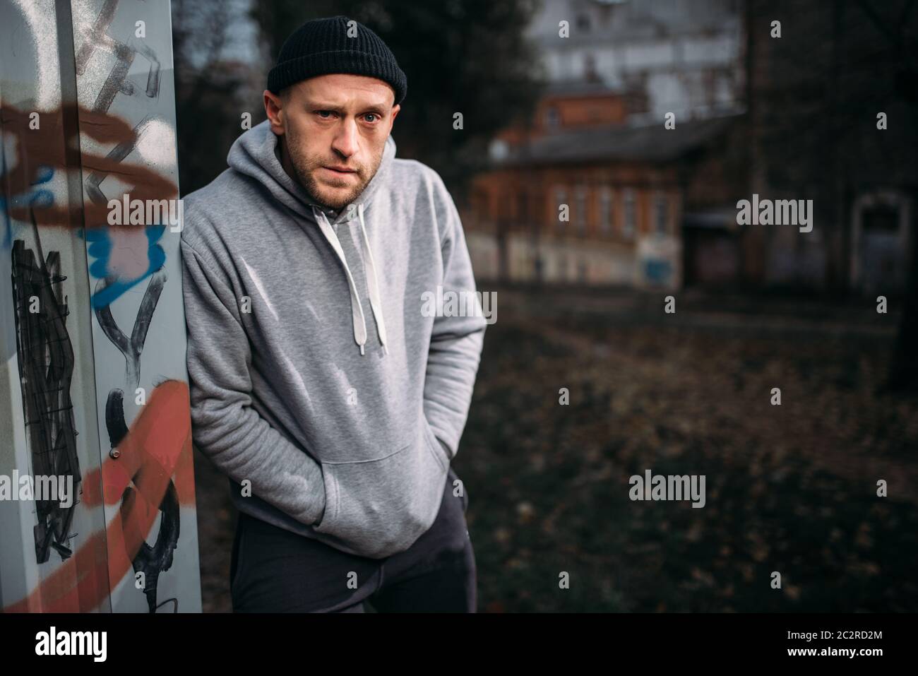 Male robber waiting for victim on the night street. Crime concept ...