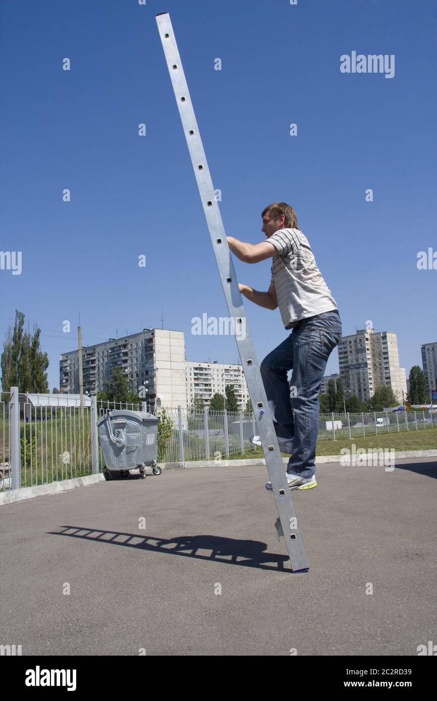 Man climbing ladder. Outdoors Stock Photo - Alamy