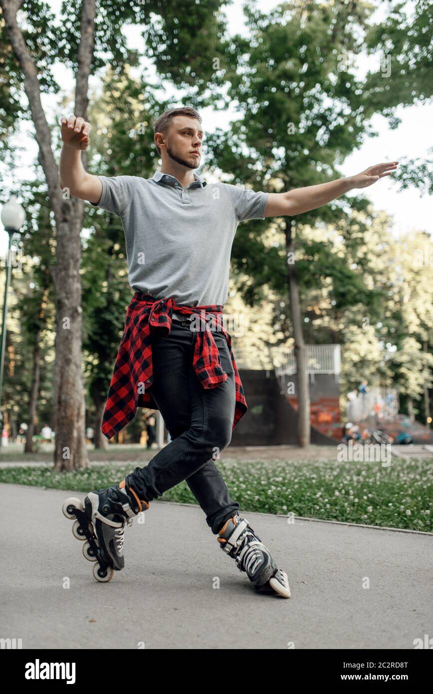 Roller skating, male skater rolling in park. Urban roller-skating ...