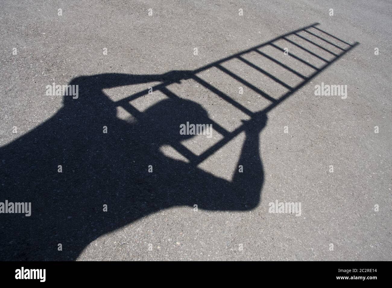 Shadow of man climbing ladder on asphalt Stock Photo - Alamy