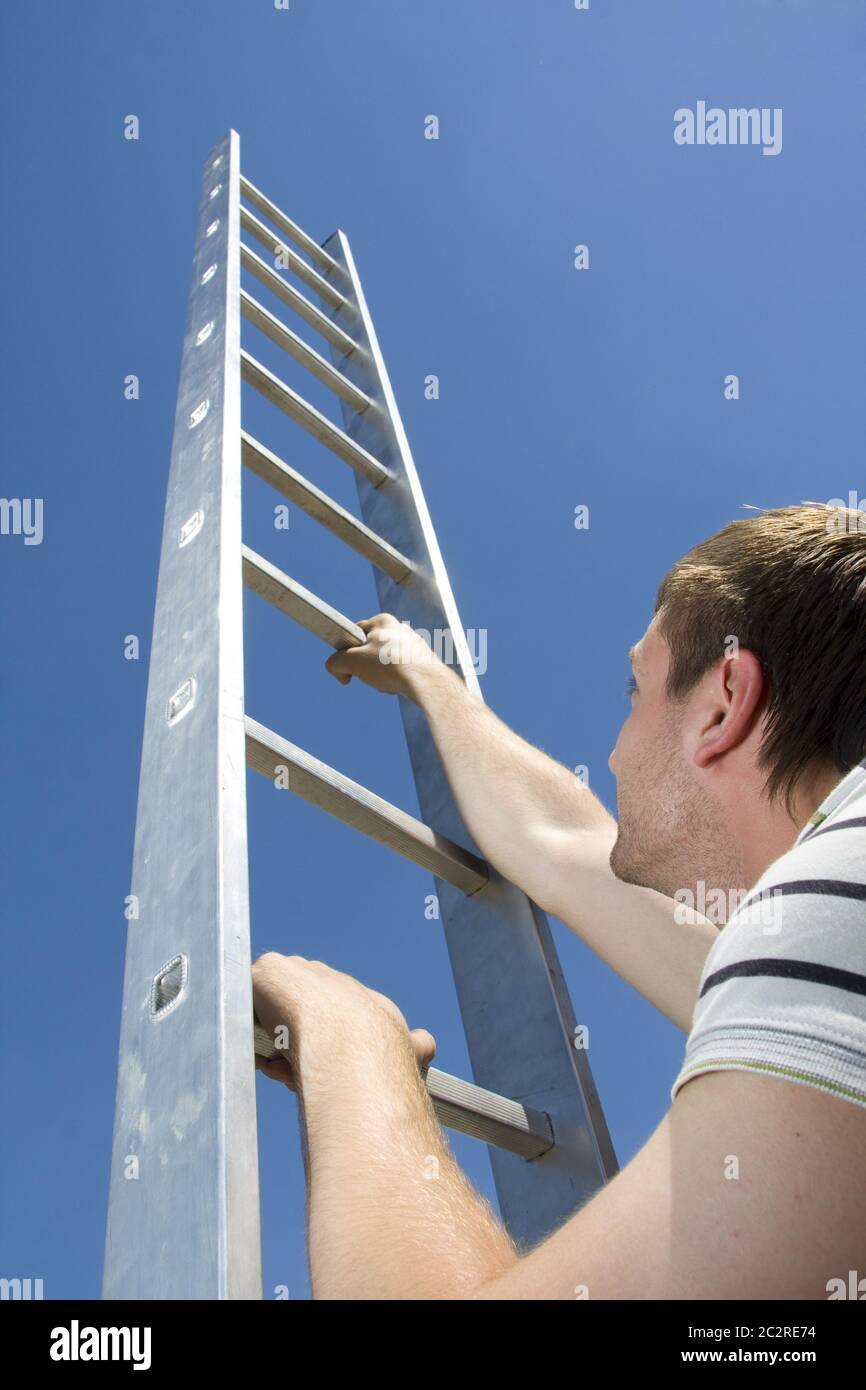 Man climbing ladder Stock Photo - Alamy