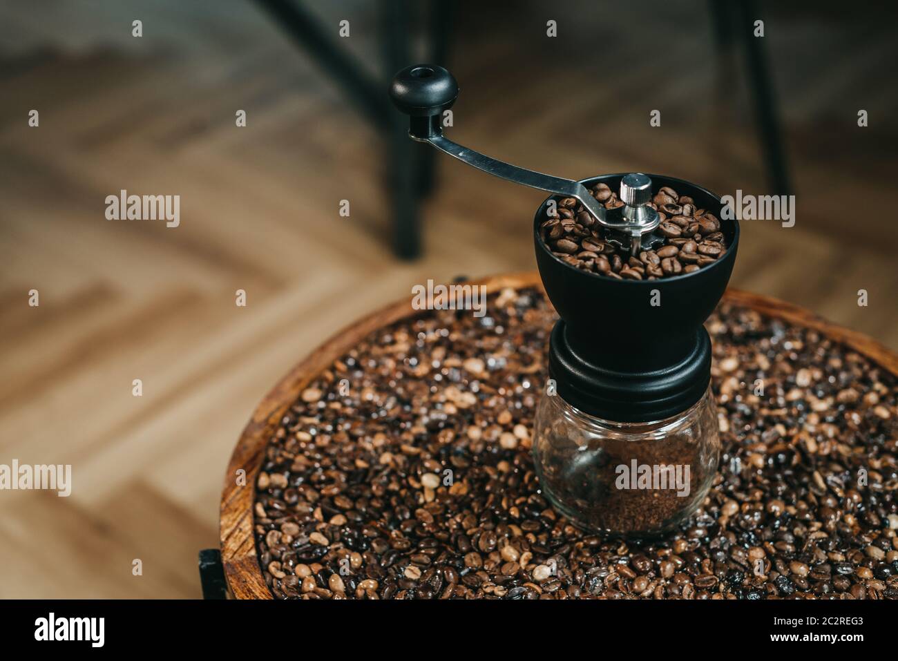 Coffee beans inside a black coffee grinder Stock Photo - Alamy