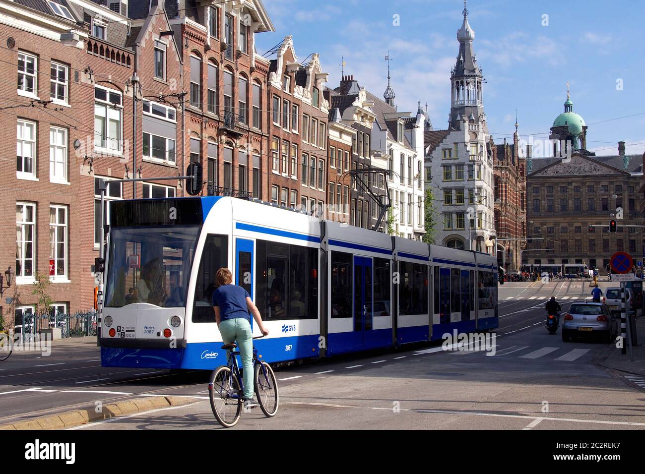 Tram travels along Raadhuisstraat in Amsterdam with cyclist and ...