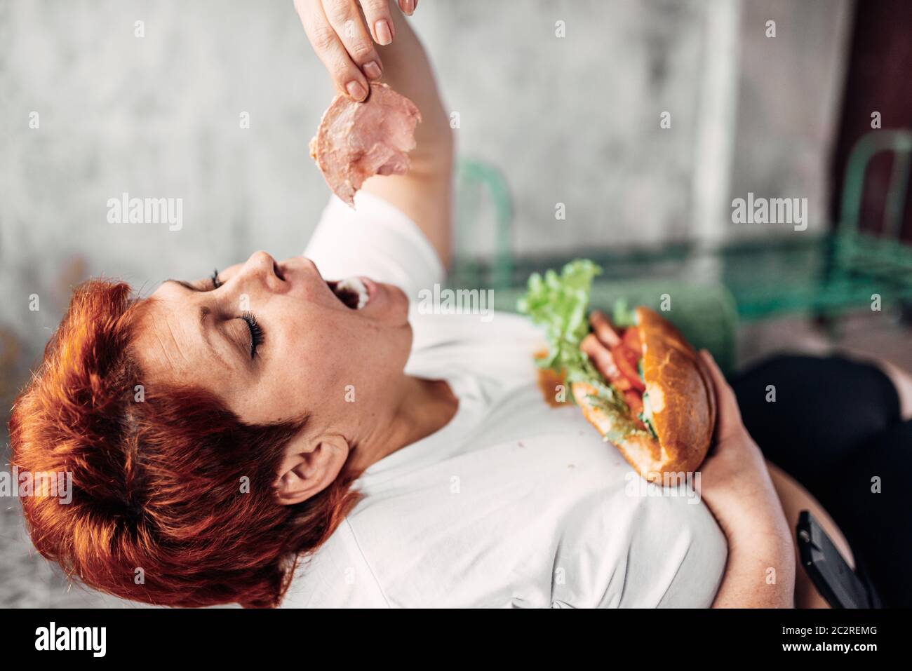 Overweight woman eats sandwich, bulimic, obesity problem. Unhealthy ...