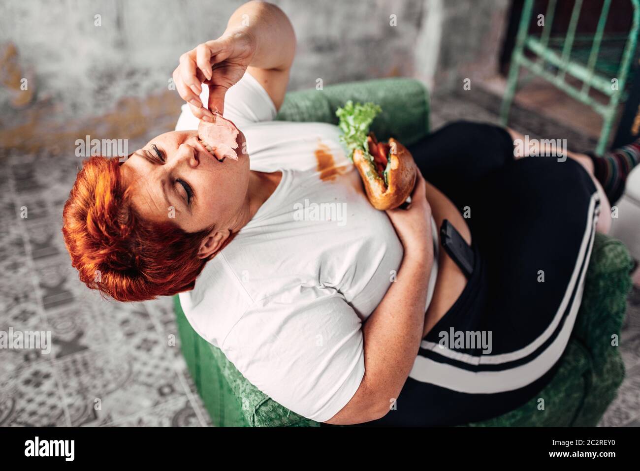 Overweight woman eats sandwich, bulimic, obesity problem. Unhealthy ...