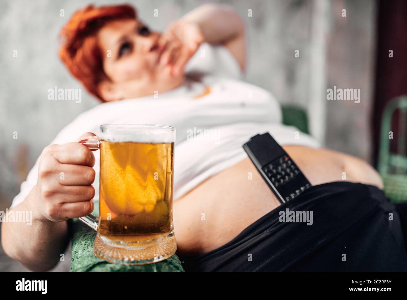 Overweight woman with glass of beer in hand, obesity. Unhealthy ...