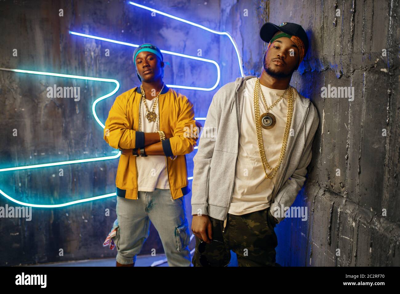 Two black rappers, perfomance in club with neon lights on background ...