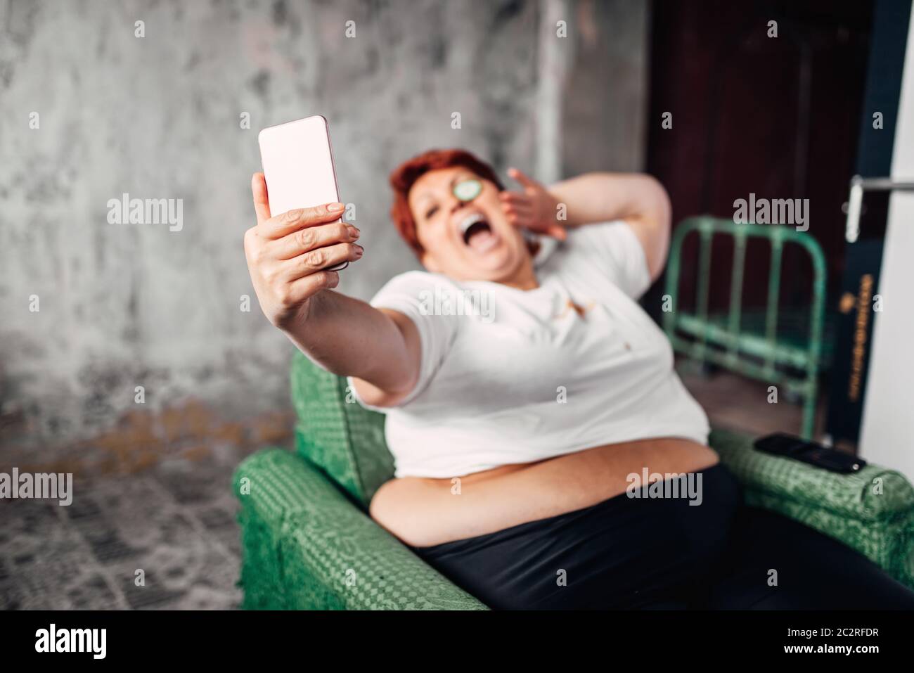 Overweight woman drinks beer and makes selfie, laziness and obesity ...