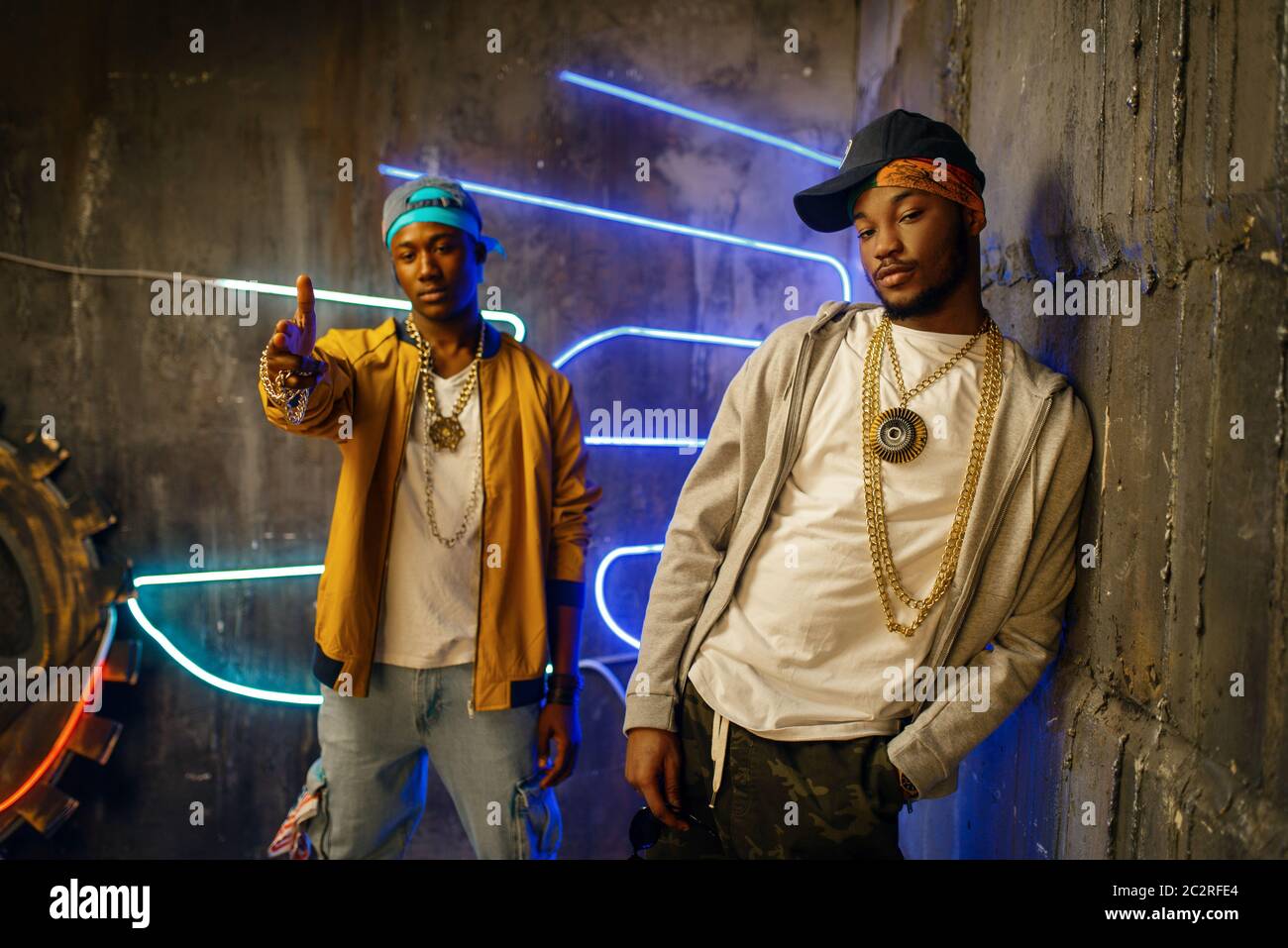 Two black rappers, perfomance in club with neon lights on background ...