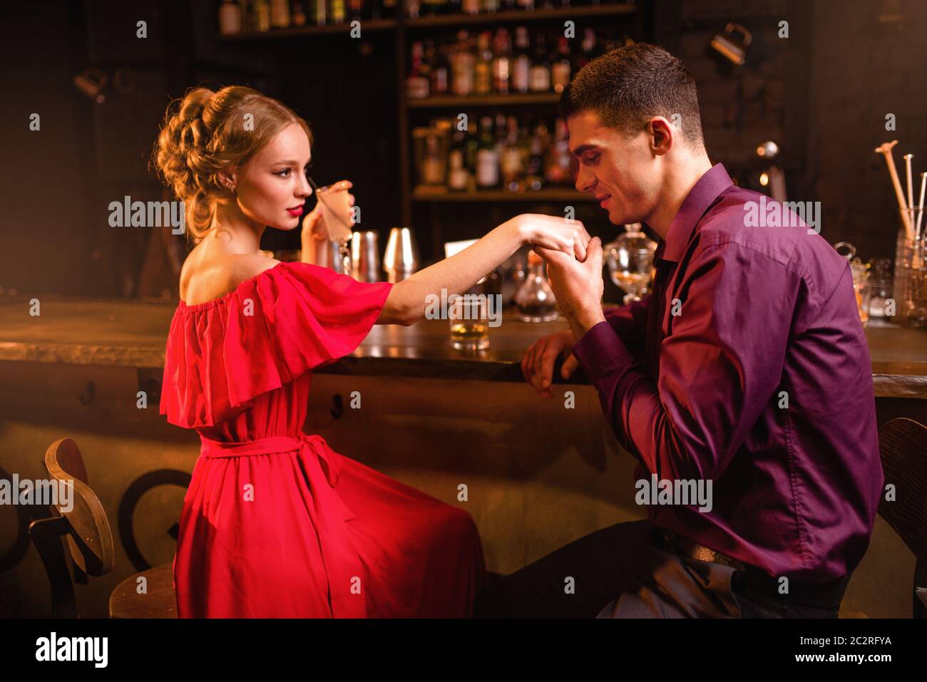 Romantic date in restaurant, attractive woman in red dress flirts with ...