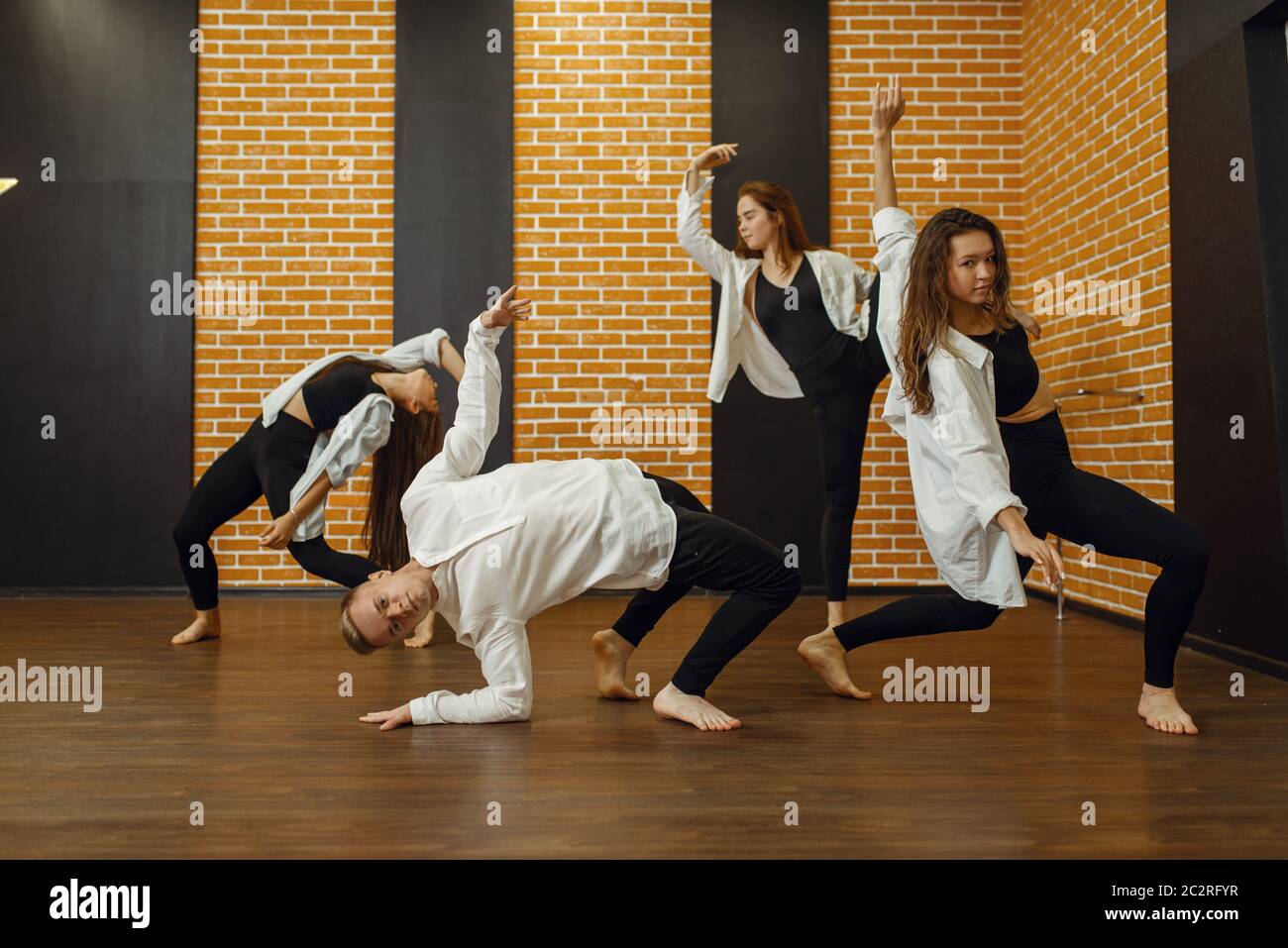 Contemporary dance group poses in studio. Female and male dancers ...
