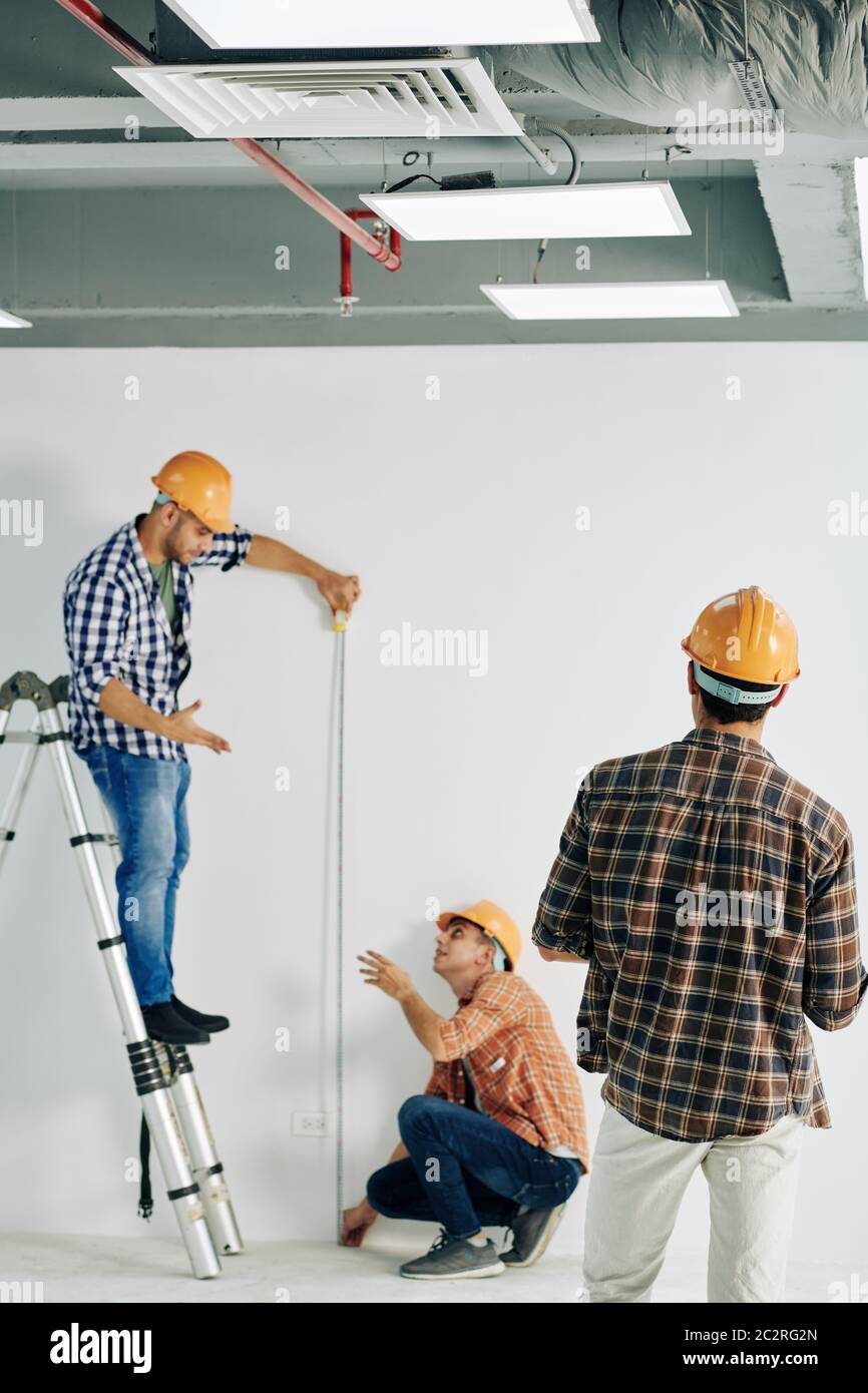 Vertical shot of professional construction worker standing on ...