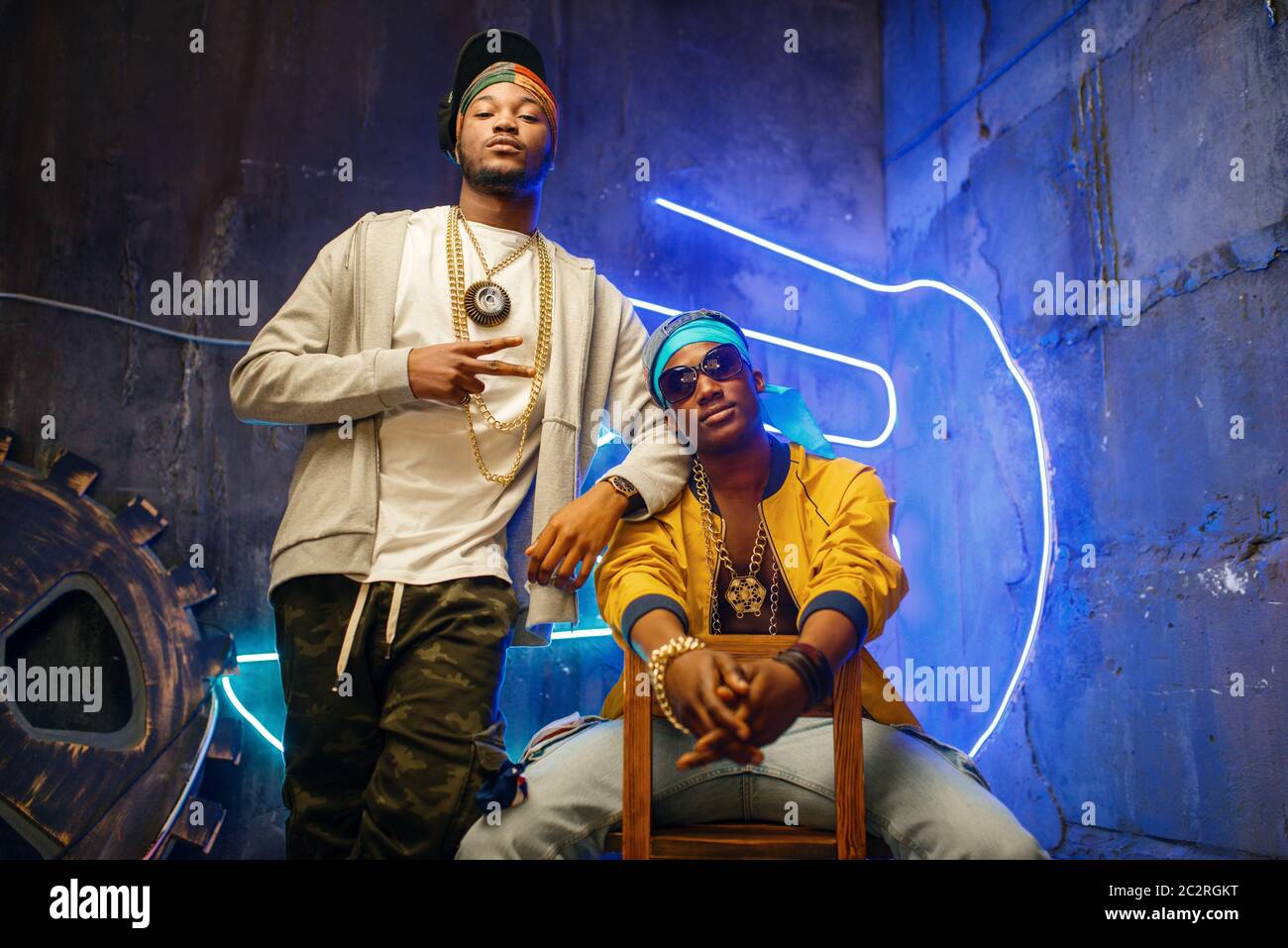 Two black rappers, neon lights on background. Rap performers in subway ...