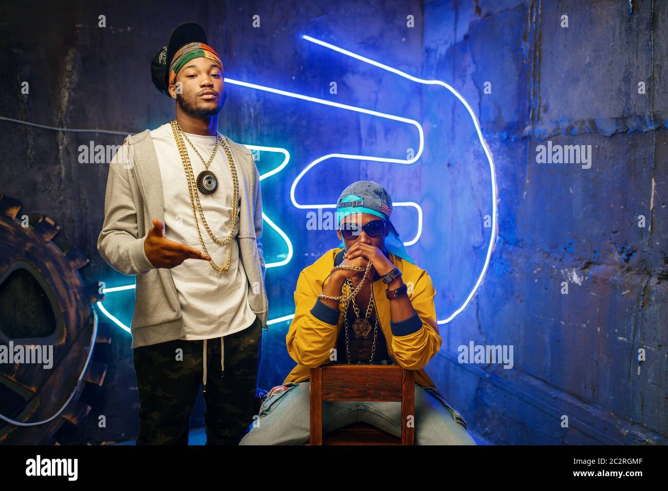 Two black rappers, neon lights on background. Rap performers in subway ...