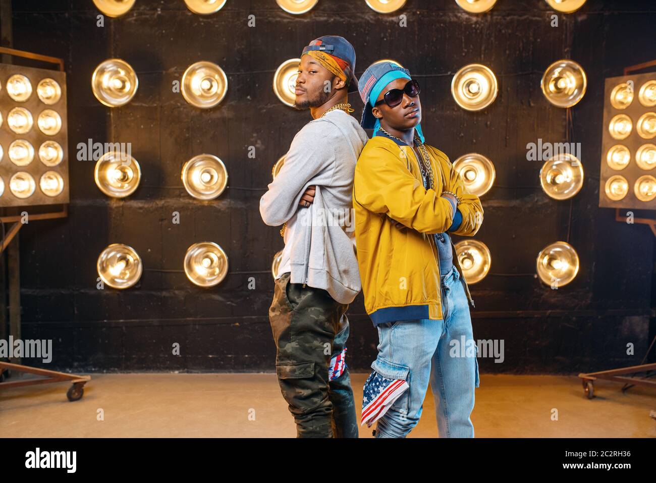 Two black rappers, dance perfomance on stage with spotlights on ...