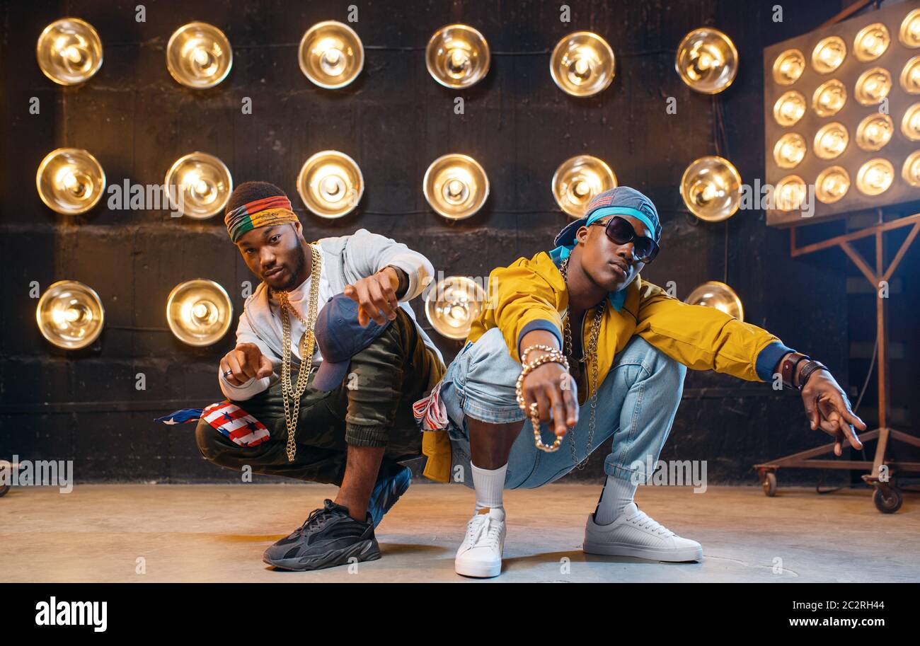 Two black rappers sitting on the floor, perfomance on stage with ...