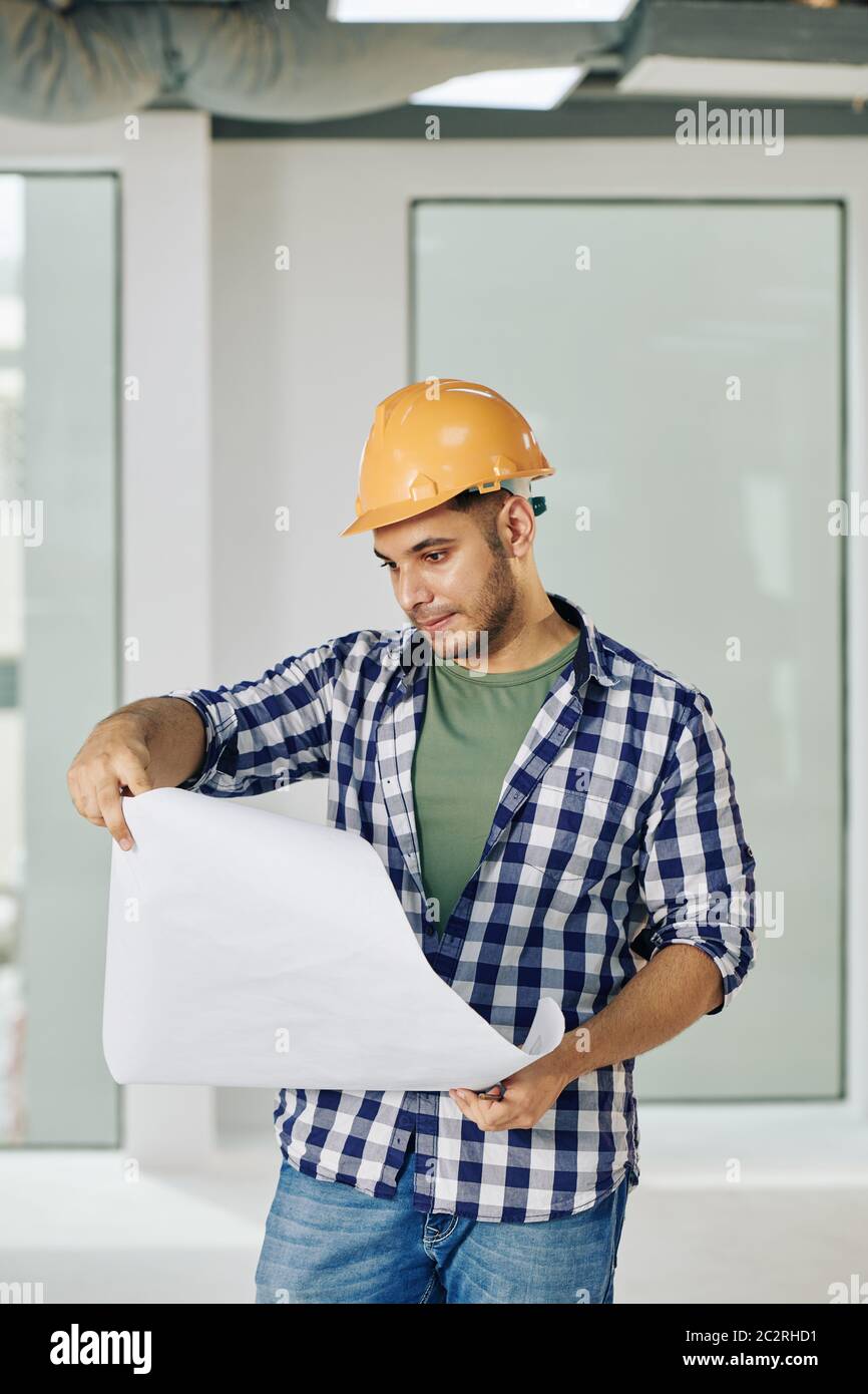 Portrait of professional construction engineer with serious facial ...