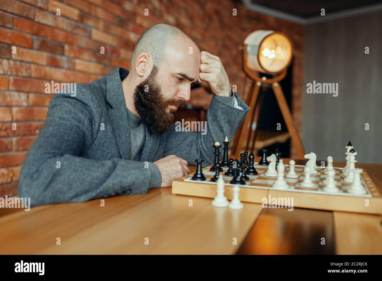 Male chess player playing black figures, thinking process. Chessplayer ...