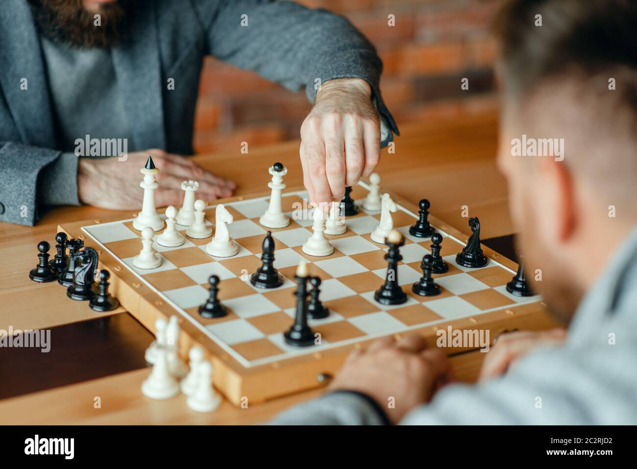 Male chess players playing, thinking process. Two chessplayers begin ...