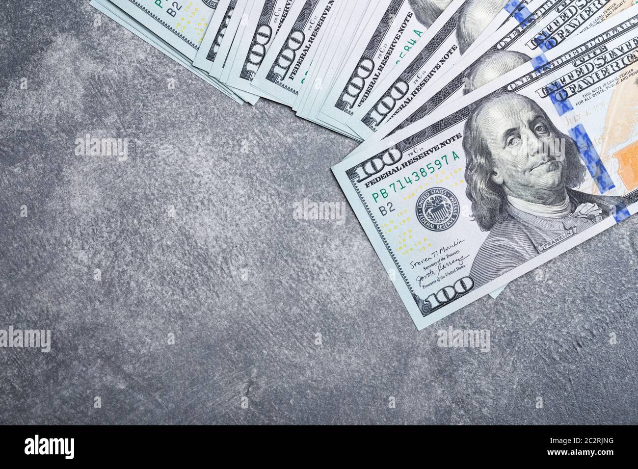 American dollar bills on grey stone background. Top view with copy ...