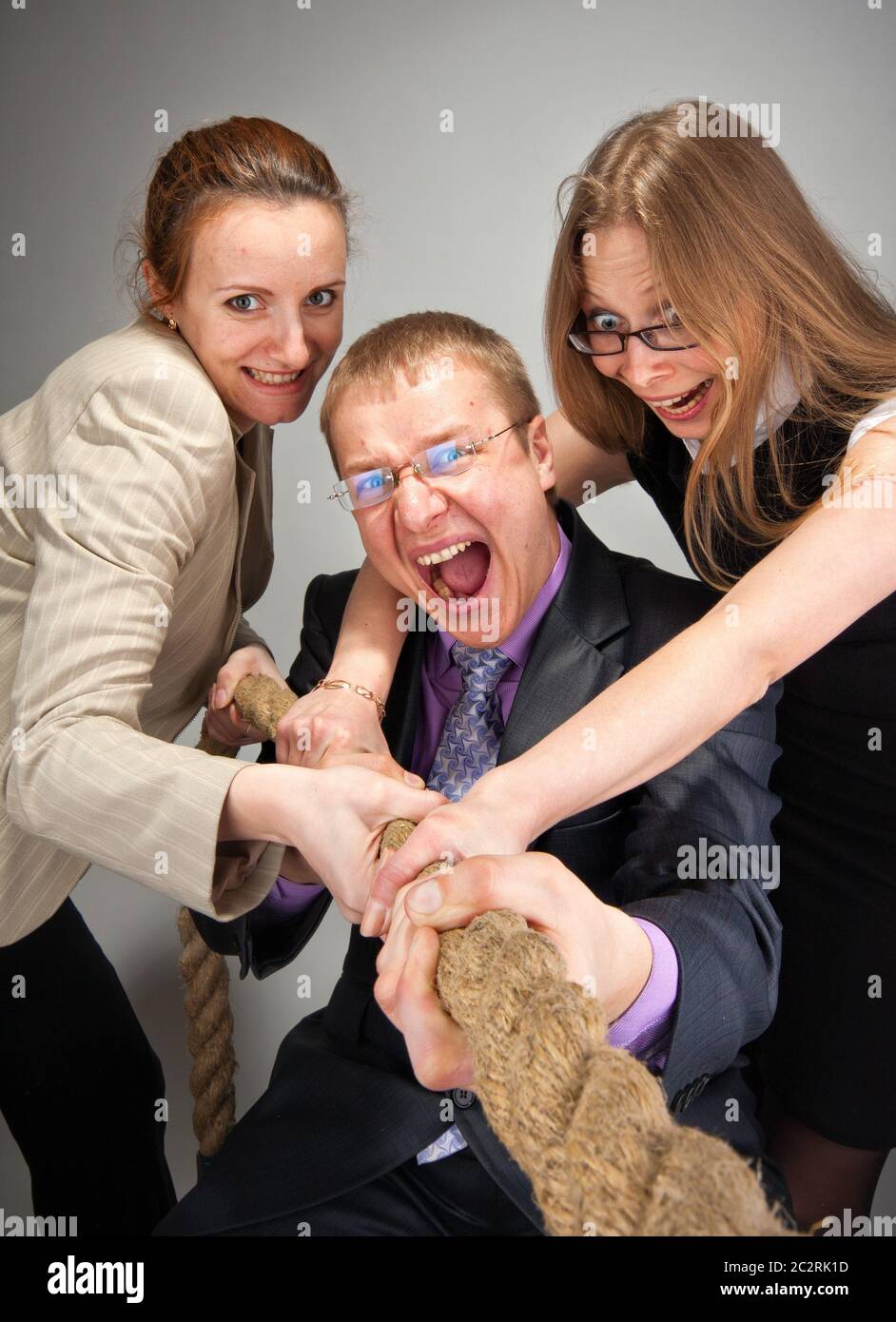 Portrait of business team pulling a rope Stock Photo - Alamy